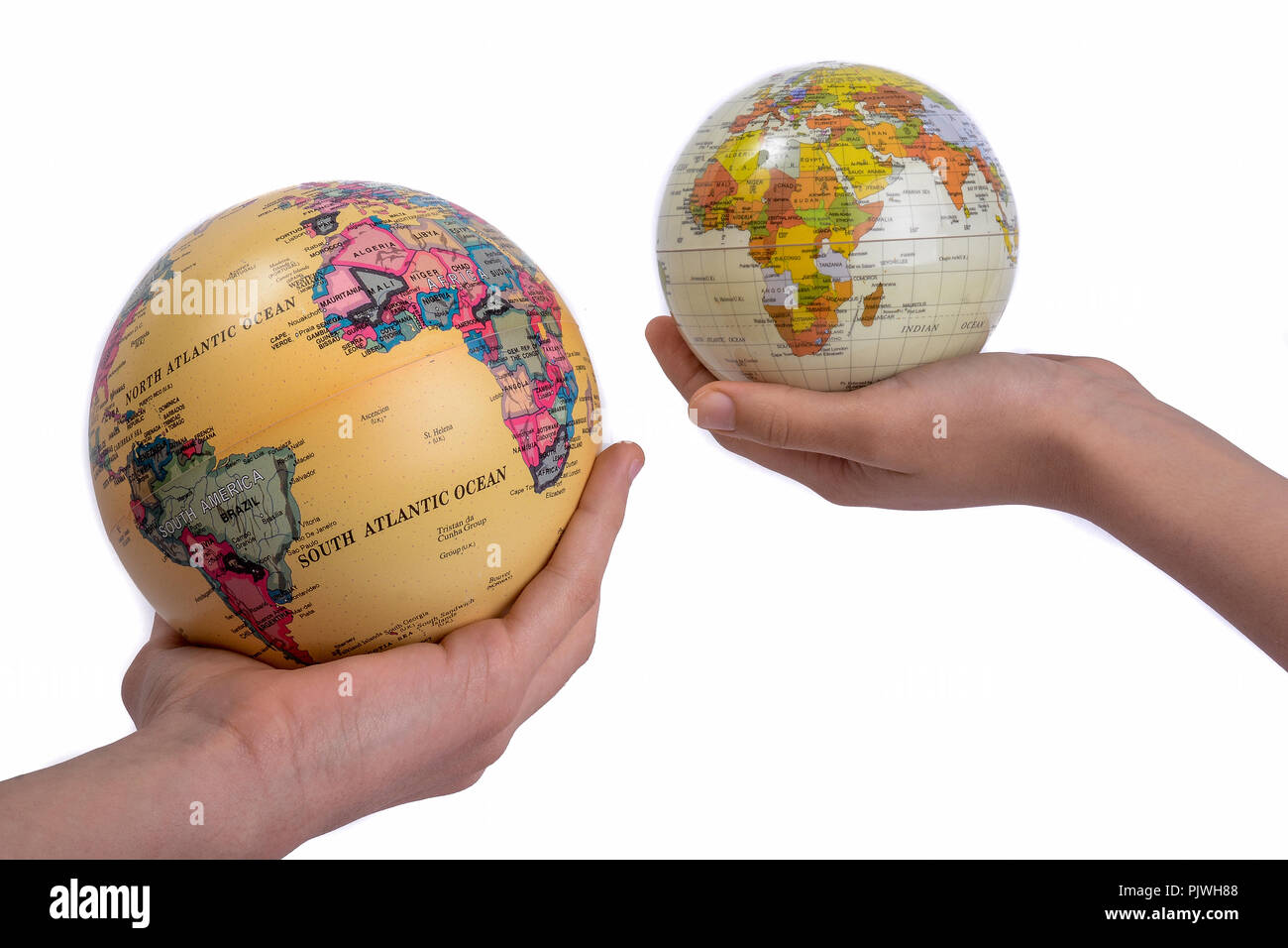 Two hands holding holding two globes in hand on white background Stock ...