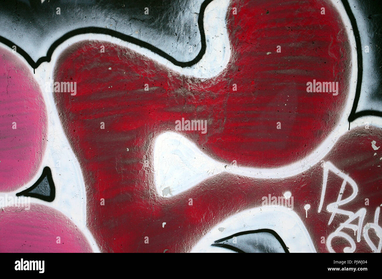 The old wall, painted in color graffiti drawing red aerosol paints ...