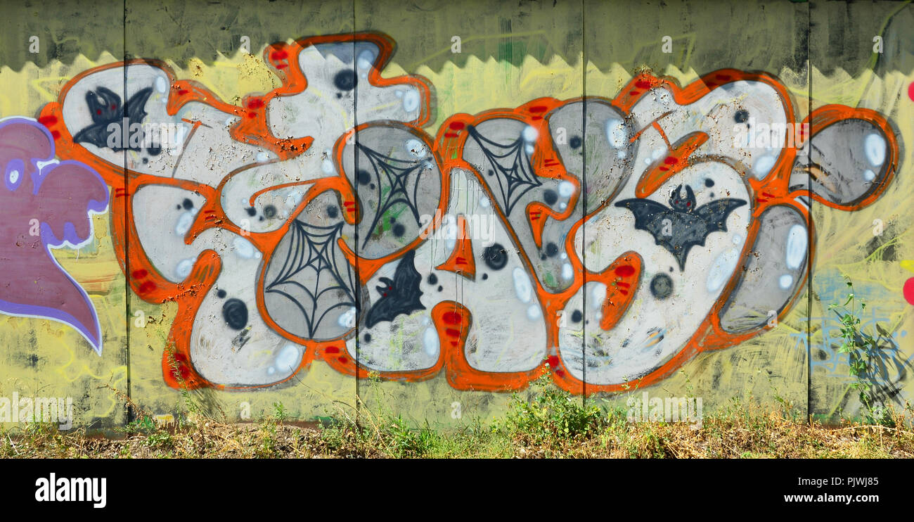 The old wall, painted in color graffiti drawing silver chrome aerosol ...