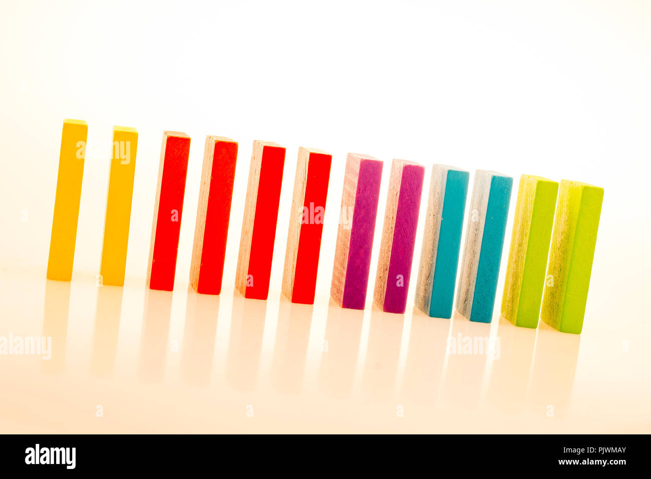 Colorful Domino Blocks in a line on a white background Stock Photo - Alamy