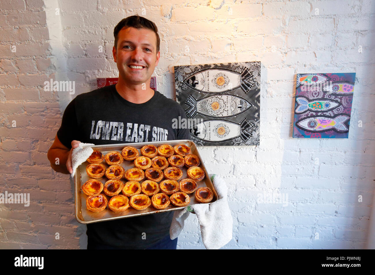 Joey Bats Cafe owner holds a tray of his award winning pasteis de nata ...