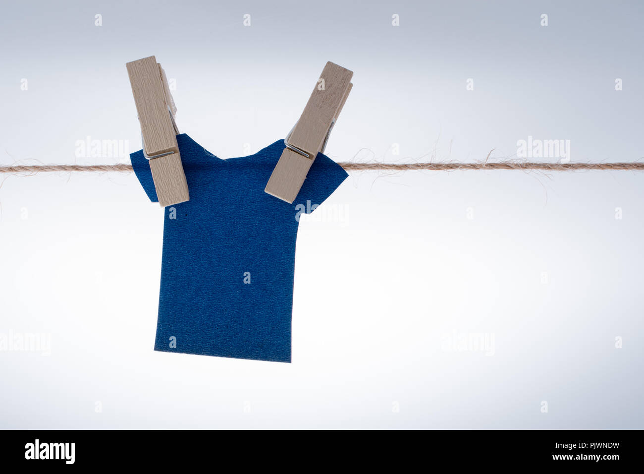 Paper clothes hang on a rope with the help of clothespins Stock Photo ...