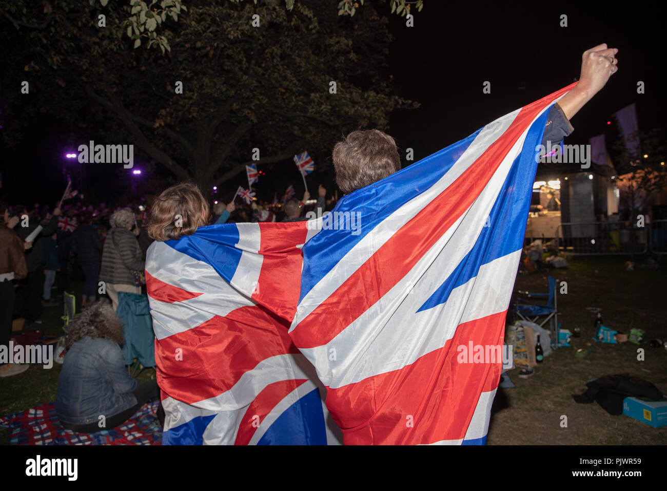 London, UK. 8th Sep, 2018. A celebratory crowd waves Union Jack flags ...