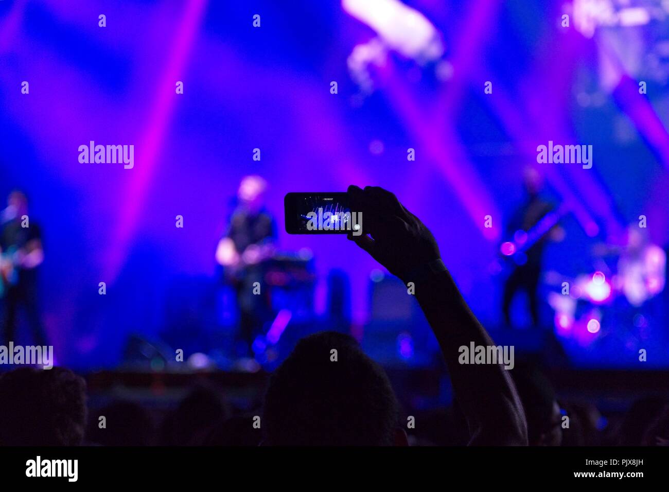 Man on his phone at a night club hi-res stock photography and images ...