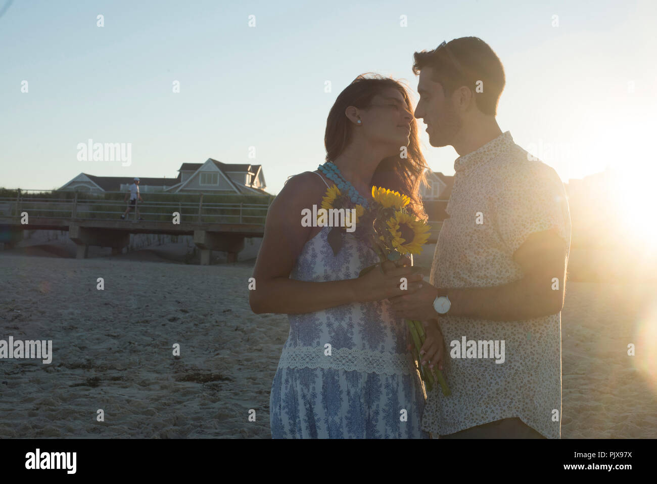 Romantic young couple face to face on beach at sunset, Spring Lake, New ...