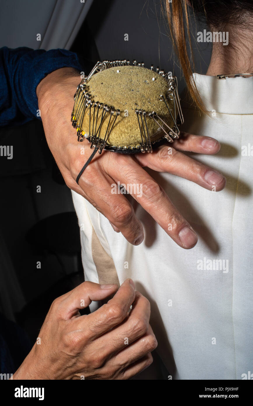 Fit model getting pinned into jacket Stock Photo - Alamy