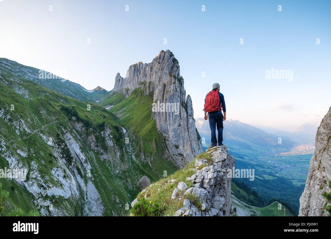 Tourist on the high rocks background. Sport and active life concept ...