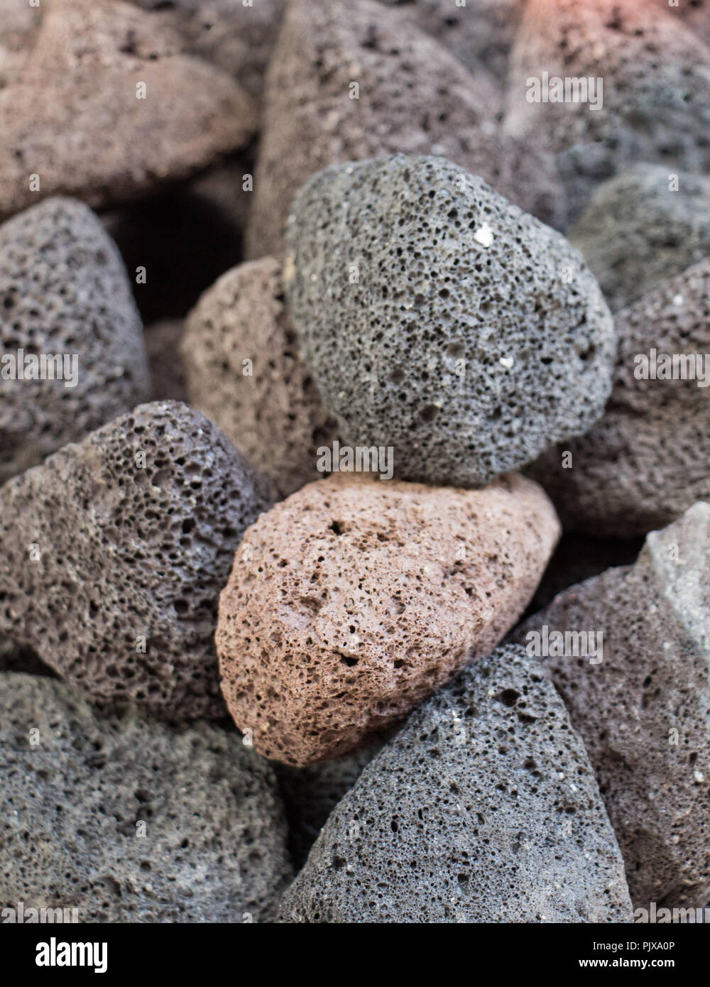 Many multicolored porous pumice stones in view Stock Photo - Alamy