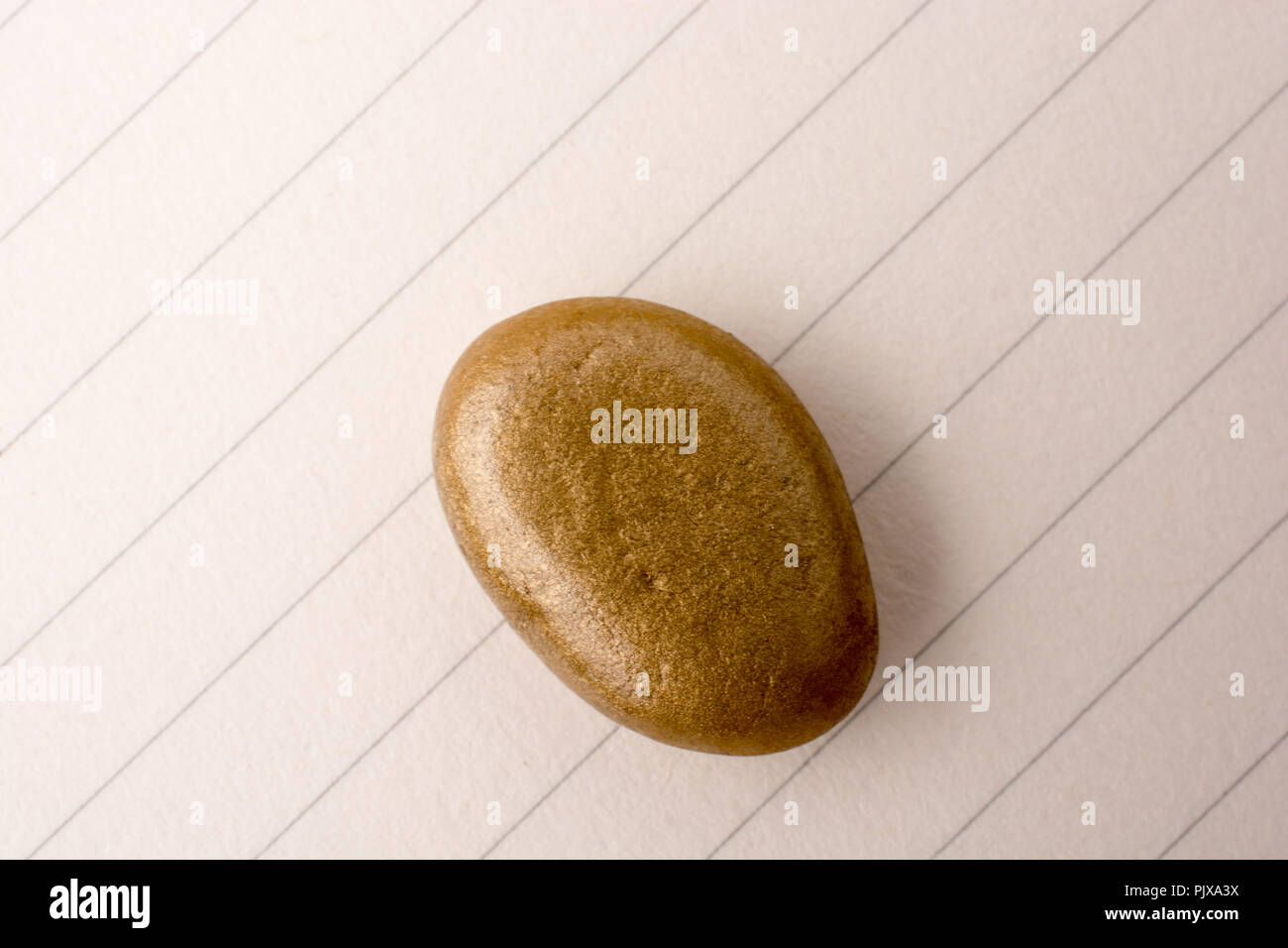 Little gold color stone on with a background Stock Photo - Alamy
