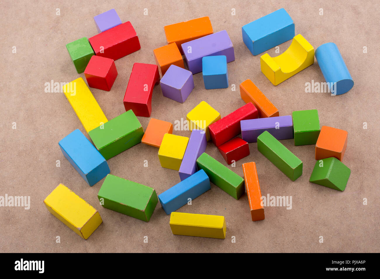 Colorful building blocks on a brown background Stock Photo - Alamy