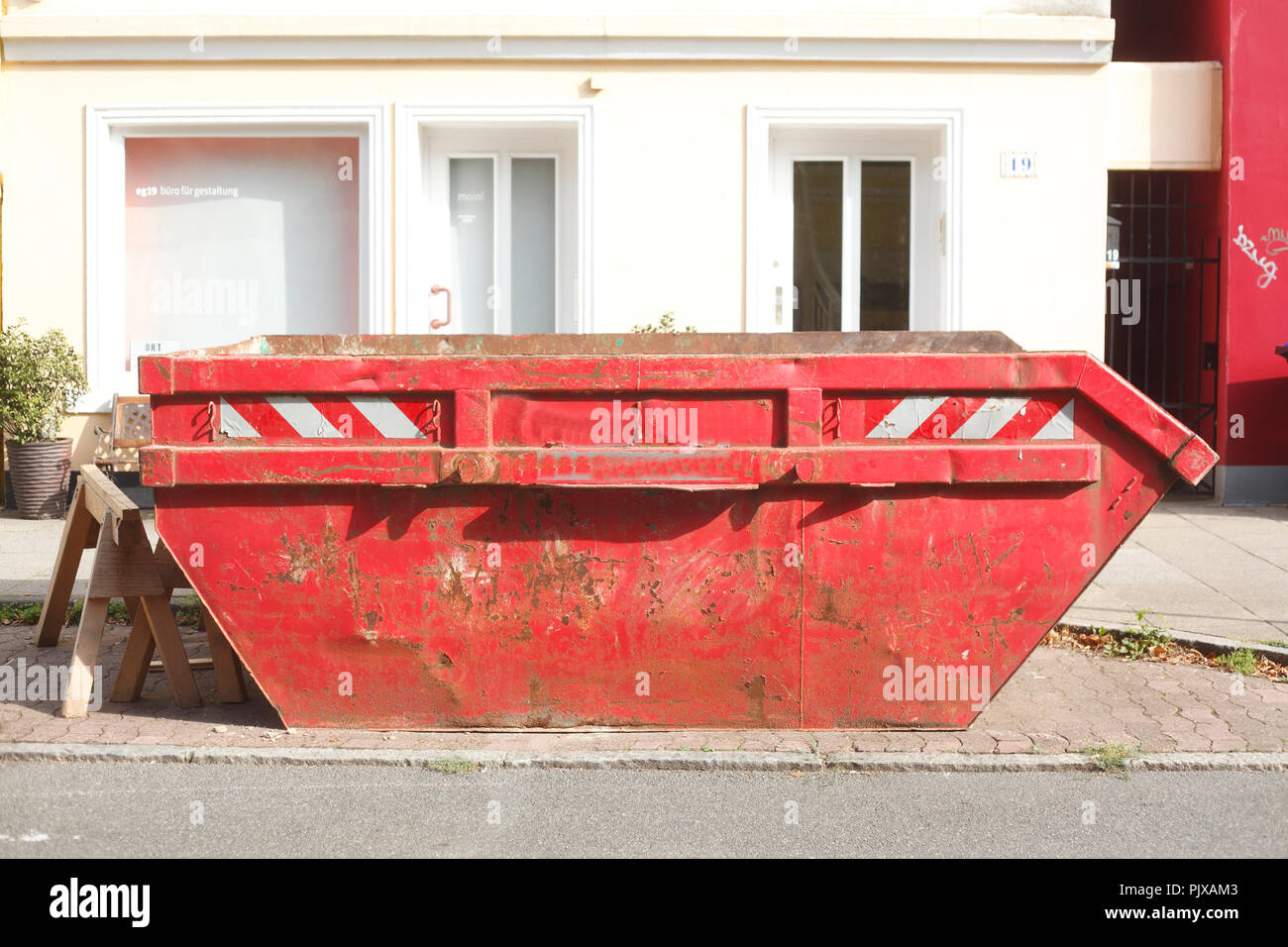 red Rubble Container on the street Stock Photo - Alamy