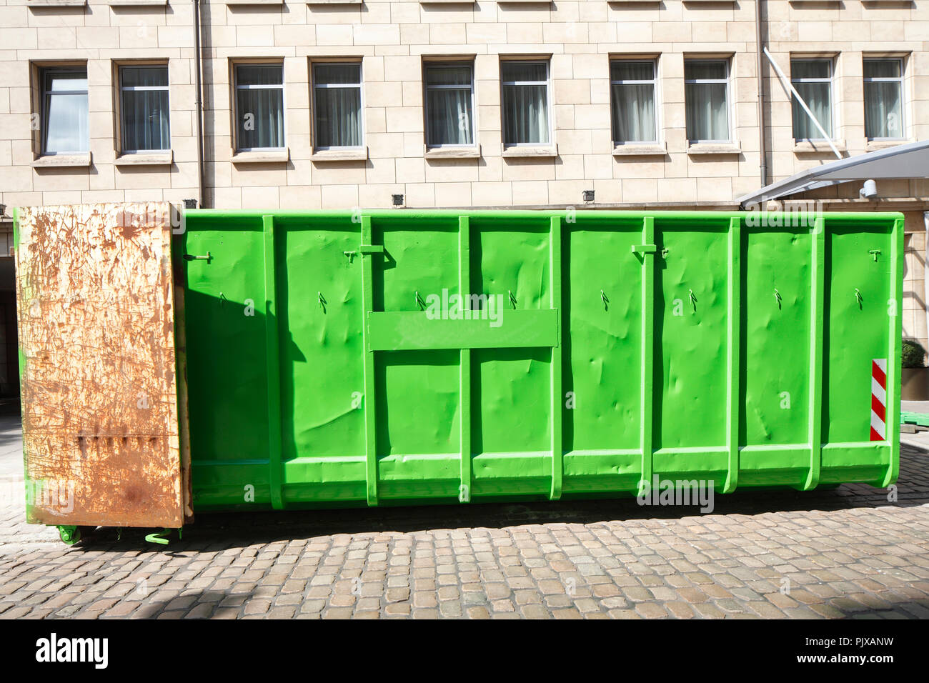 green Rubble Container on the street Stock Photo - Alamy