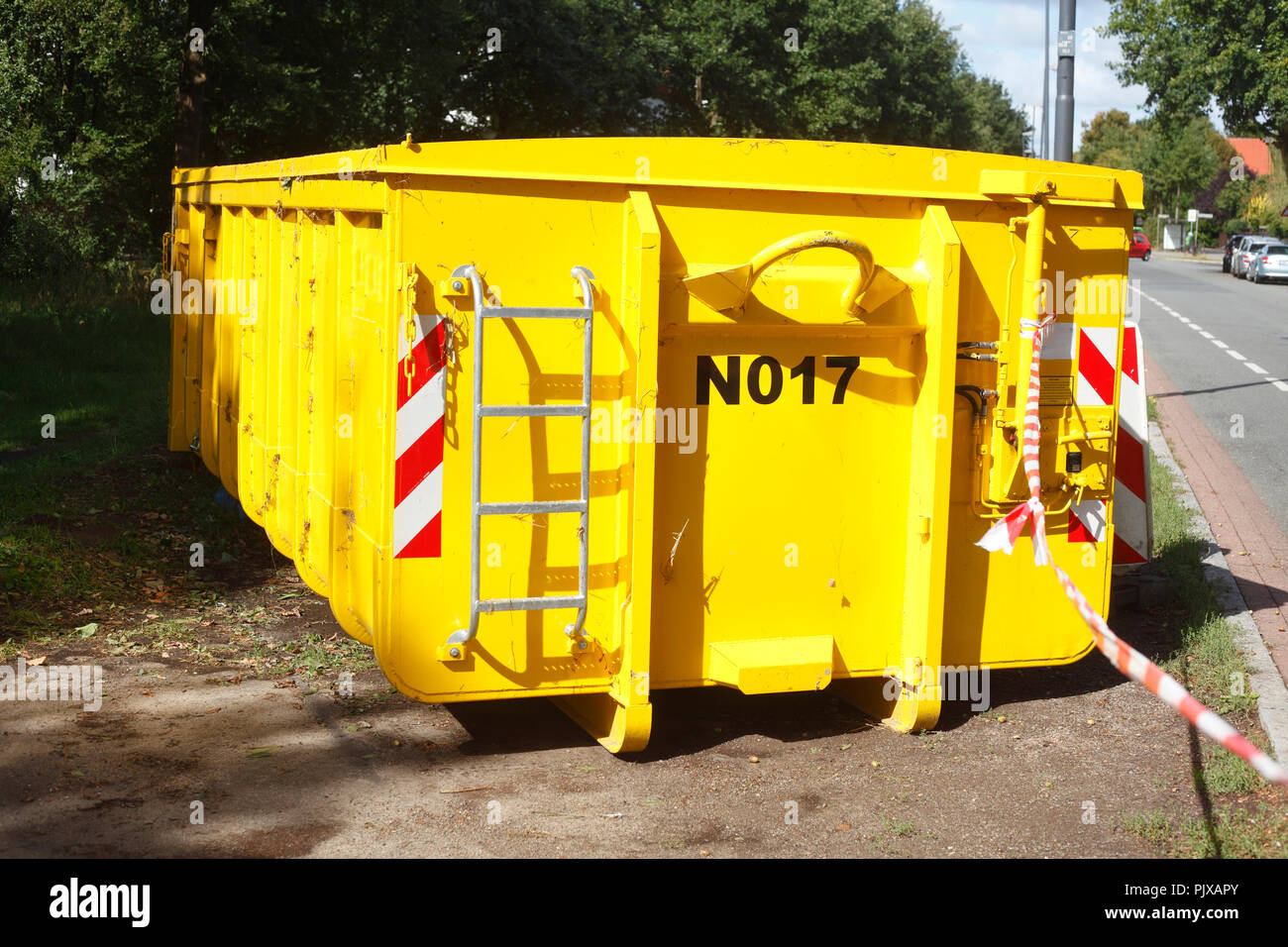 Yellow Rubble Container on the street Stock Photo - Alamy