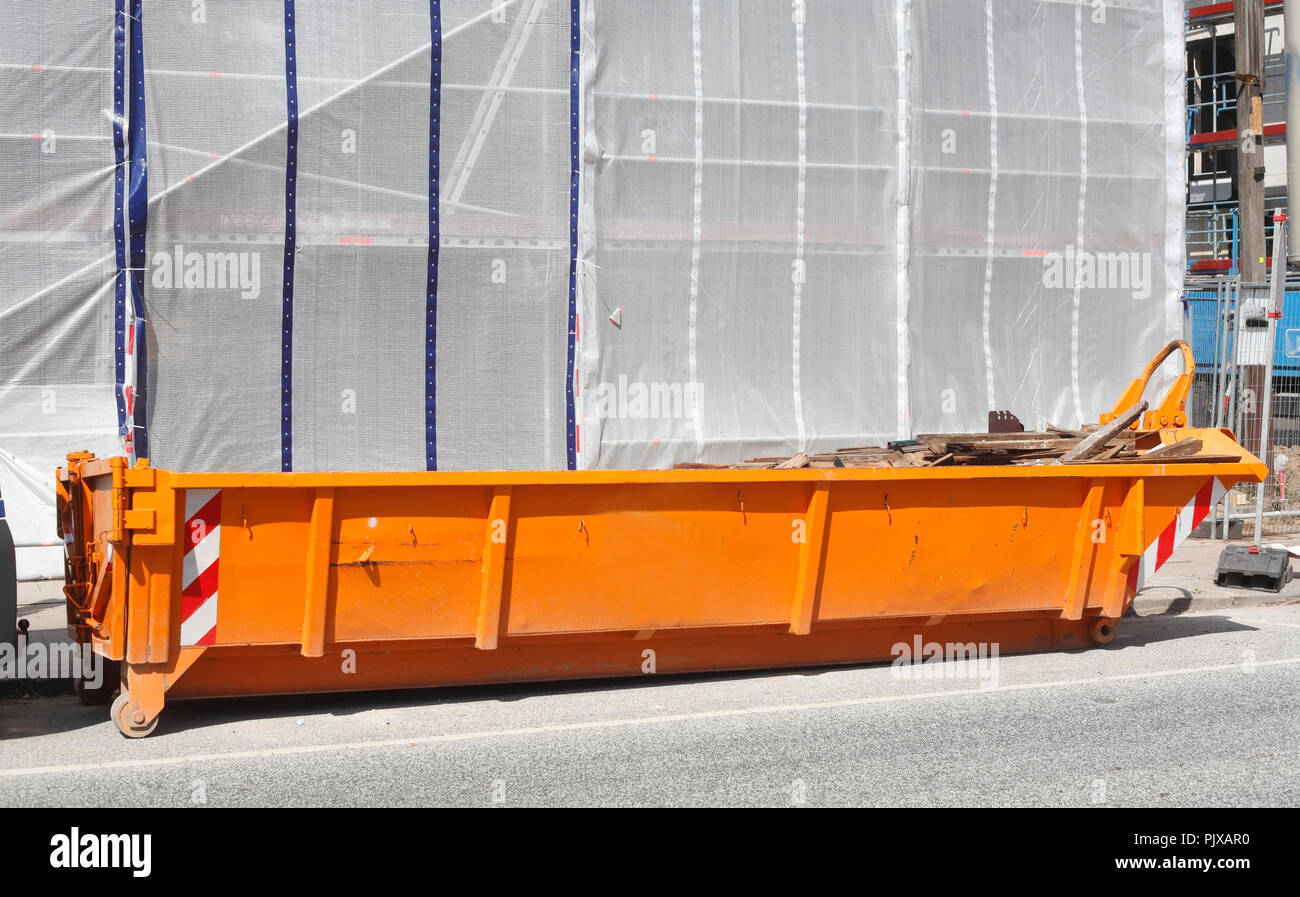 orange Rubble Container on the street Stock Photo - Alamy