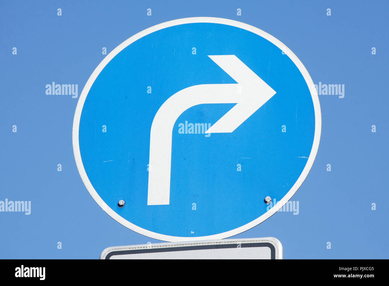 Road sign Prescribed direction of travel on the right Stock Photo - Alamy