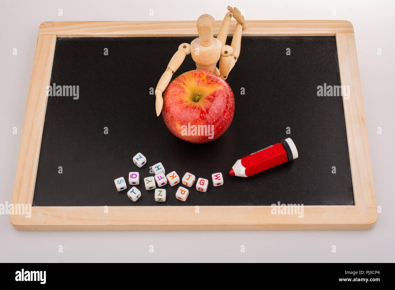 Back to school theme with a red apple and board Stock Photo - Alamy