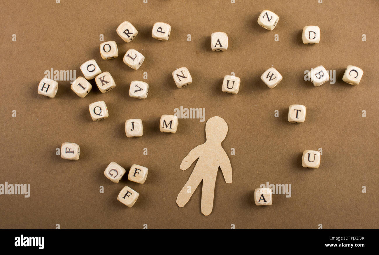 Letter cubes of made of wood and man figurine Stock Photo - Alamy