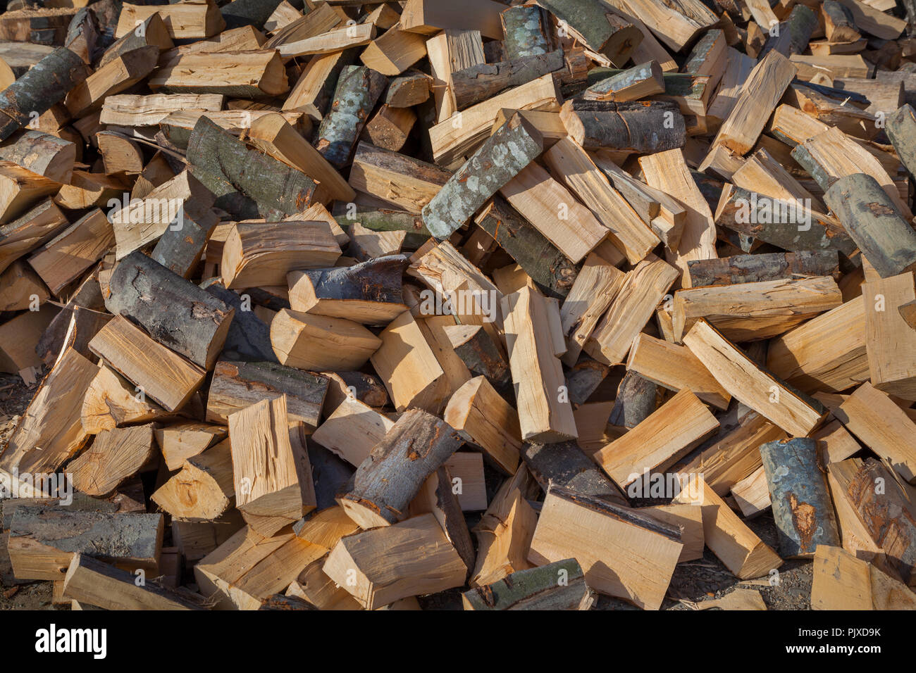 firewood background - chopped firewood on a stack Stock Photo - Alamy