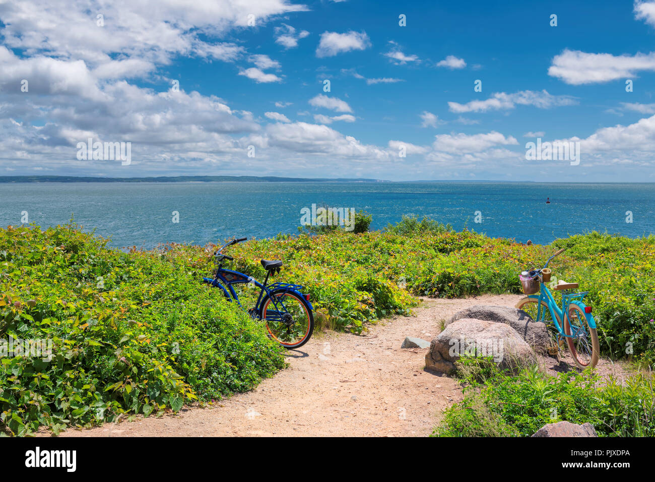 Two bicycles on the beach trail at sunny summer day in Cape Cod beach ...