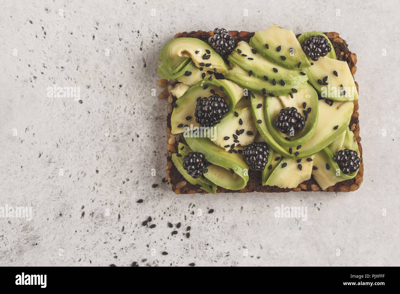 Avocado toast on a healthy sesame bread with sesame seeds on white ...