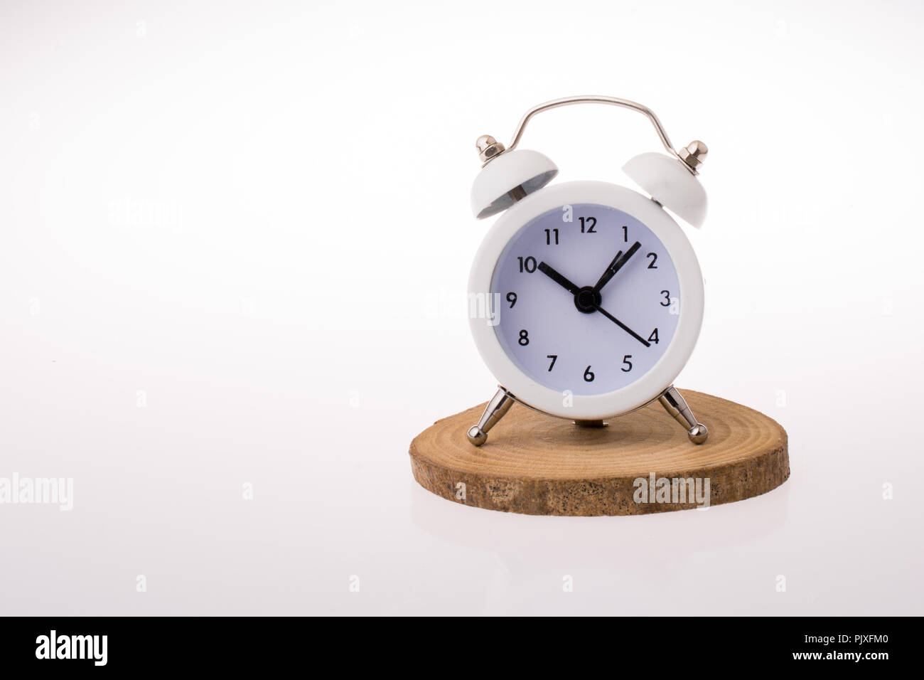 White color alarm clock on white background Stock Photo - Alamy