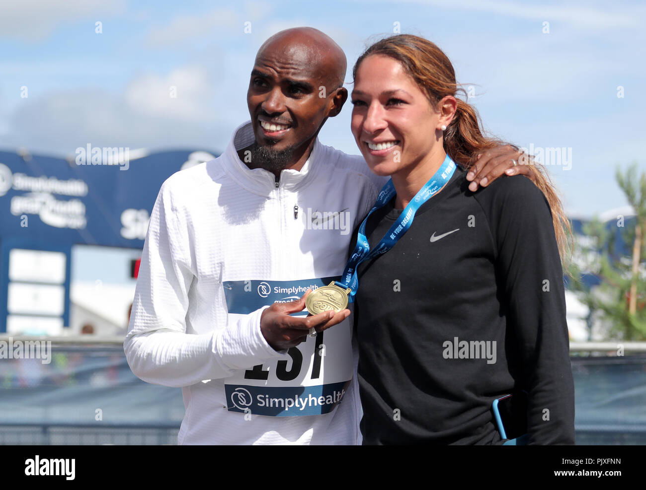 Sir Mo Farah celebrates winning the Men's Elite race along side his ...