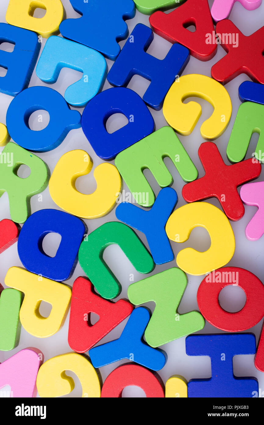 Colorful alphabet letter blocks scattered randomly on white background ...
