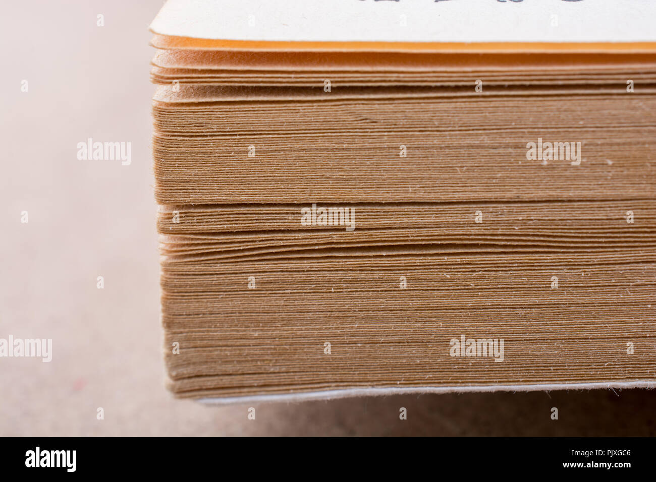 Book pages partly in view on white background Stock Photo - Alamy