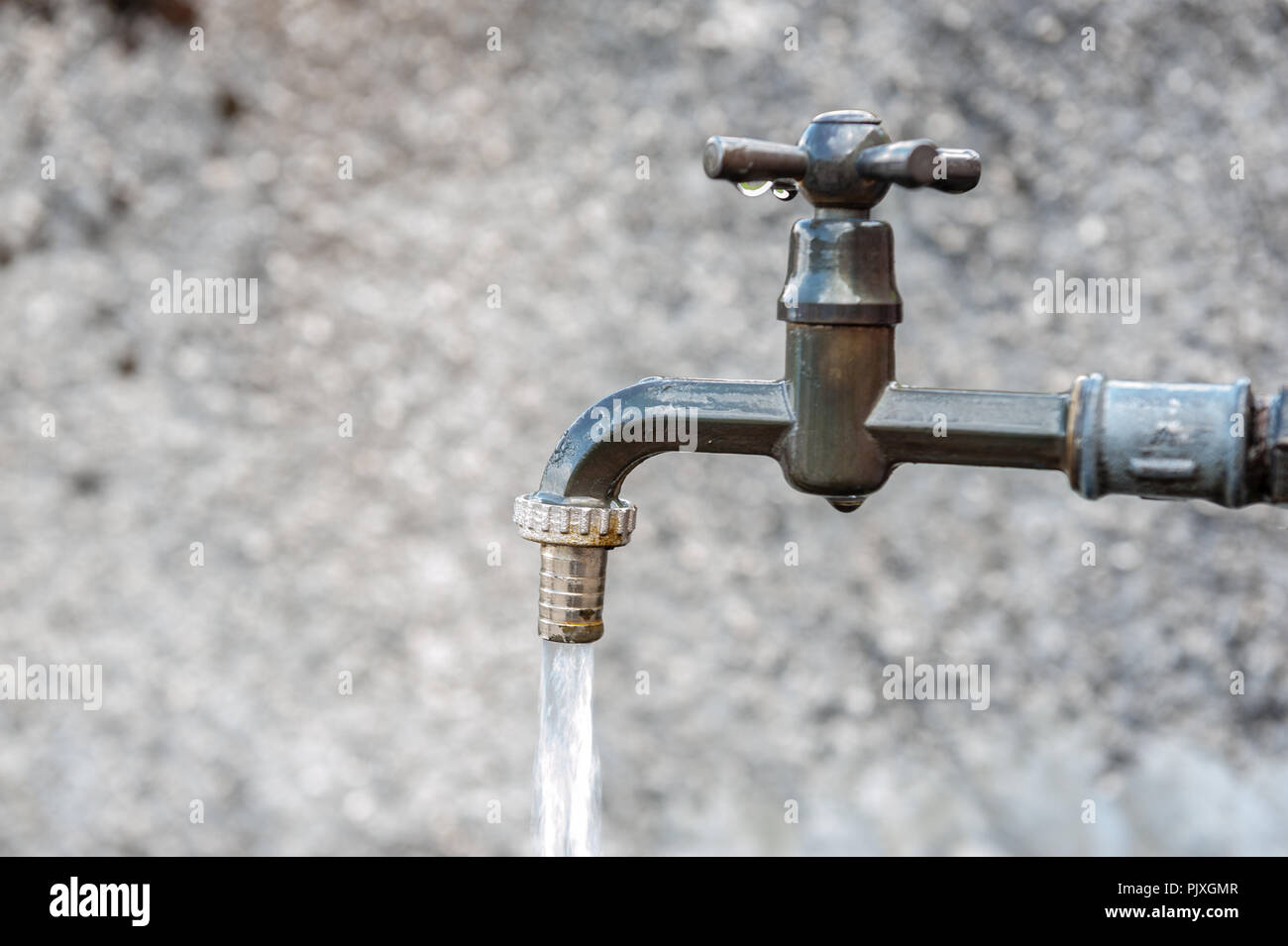 A tap from a drinking water fountain in the village of Santa Fosca, in ...