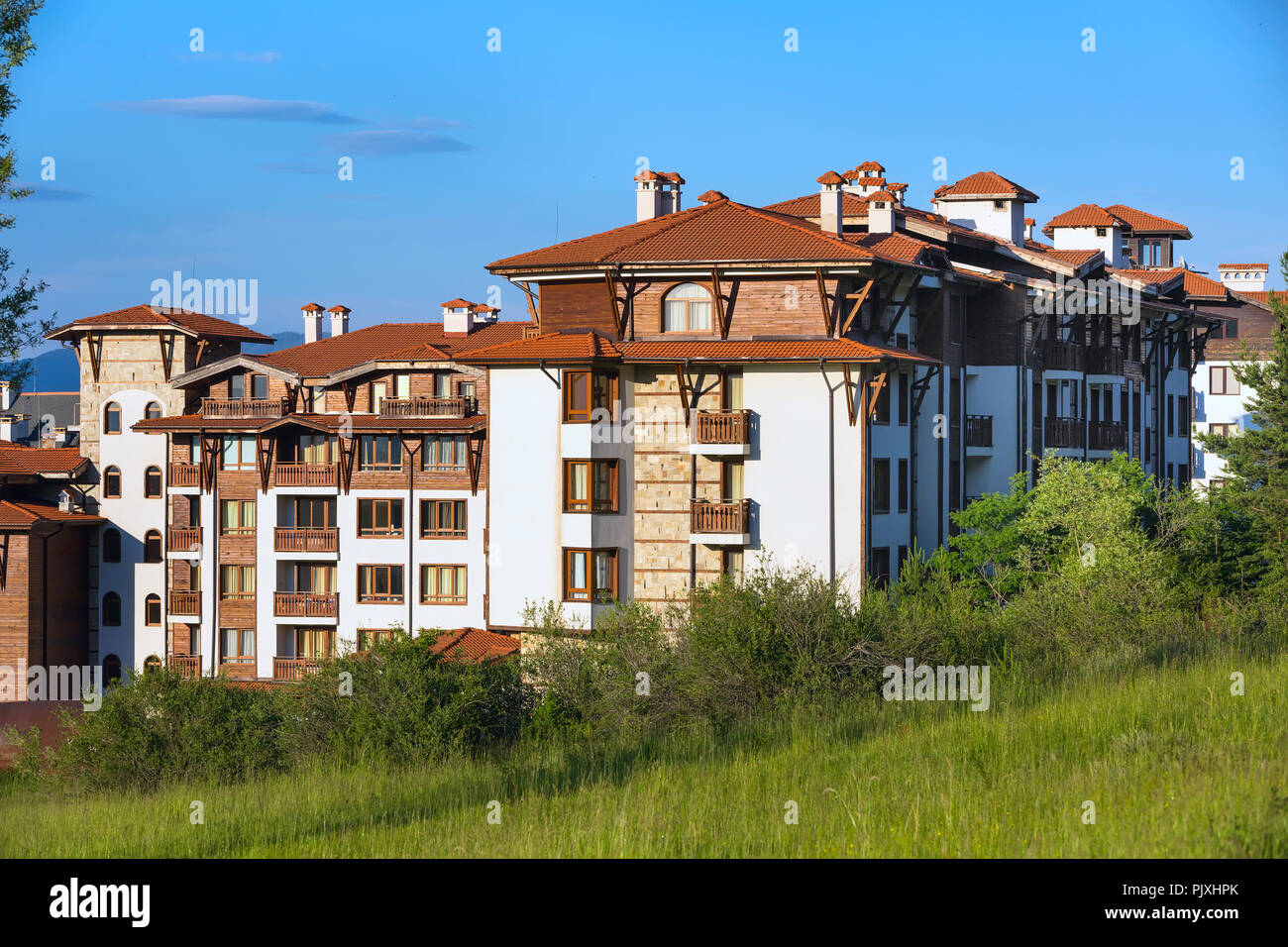 Wooden chalet hotel houses and summer panorama in bulgarian all season ...
