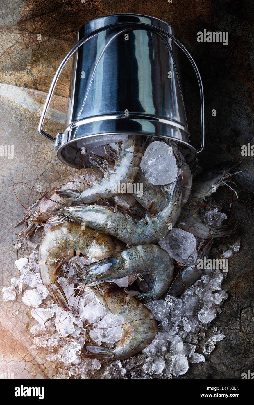 Raw and fresh shrimps or prawns and ice bucket with low and dark shadow ...