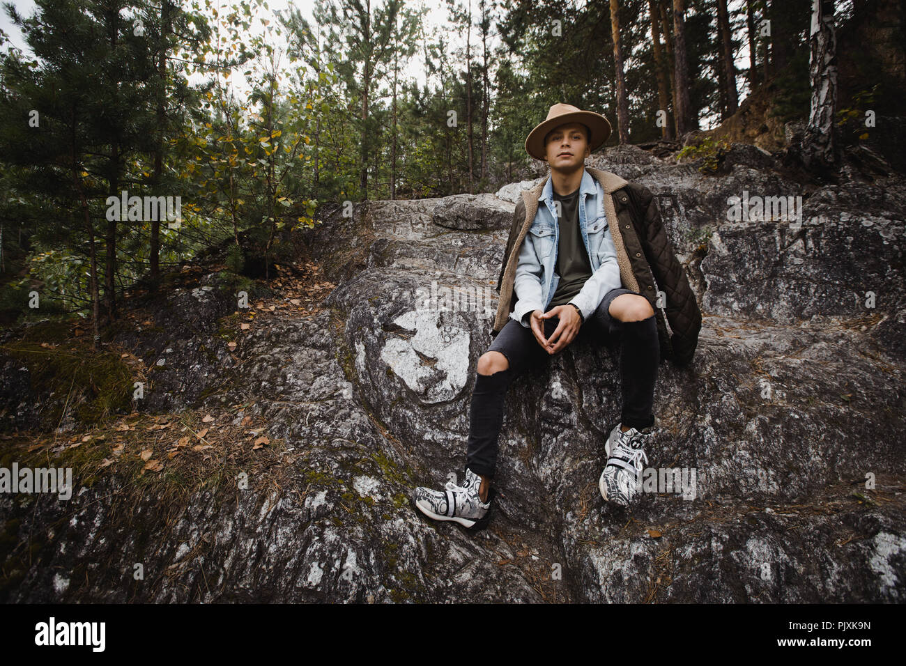 Young man sitting hi-res stock photography and images - Alamy