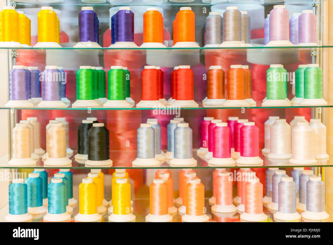 Colorful embroidery thread spool using in garment industry, row of ...