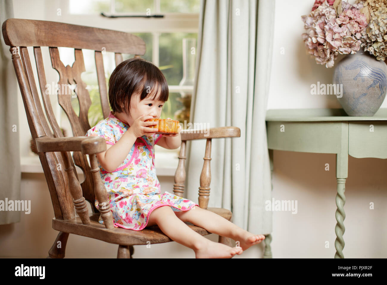 baby girl eating mooncake celebrating Chinese middle Autumn day Stock ...