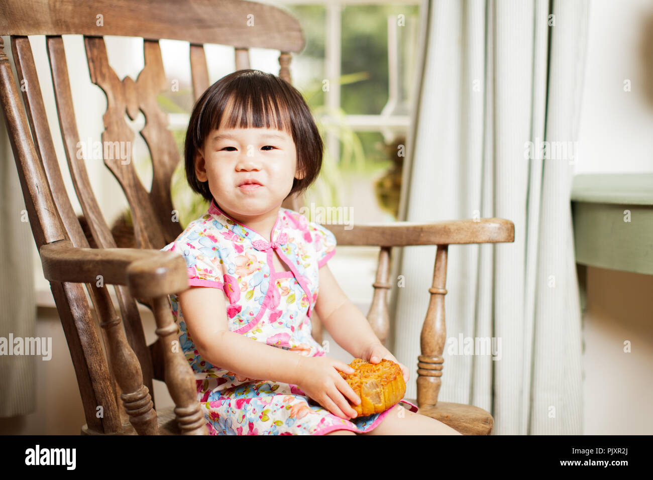 baby girl eating mooncake celebrating Chinese middle Autumn day Stock ...