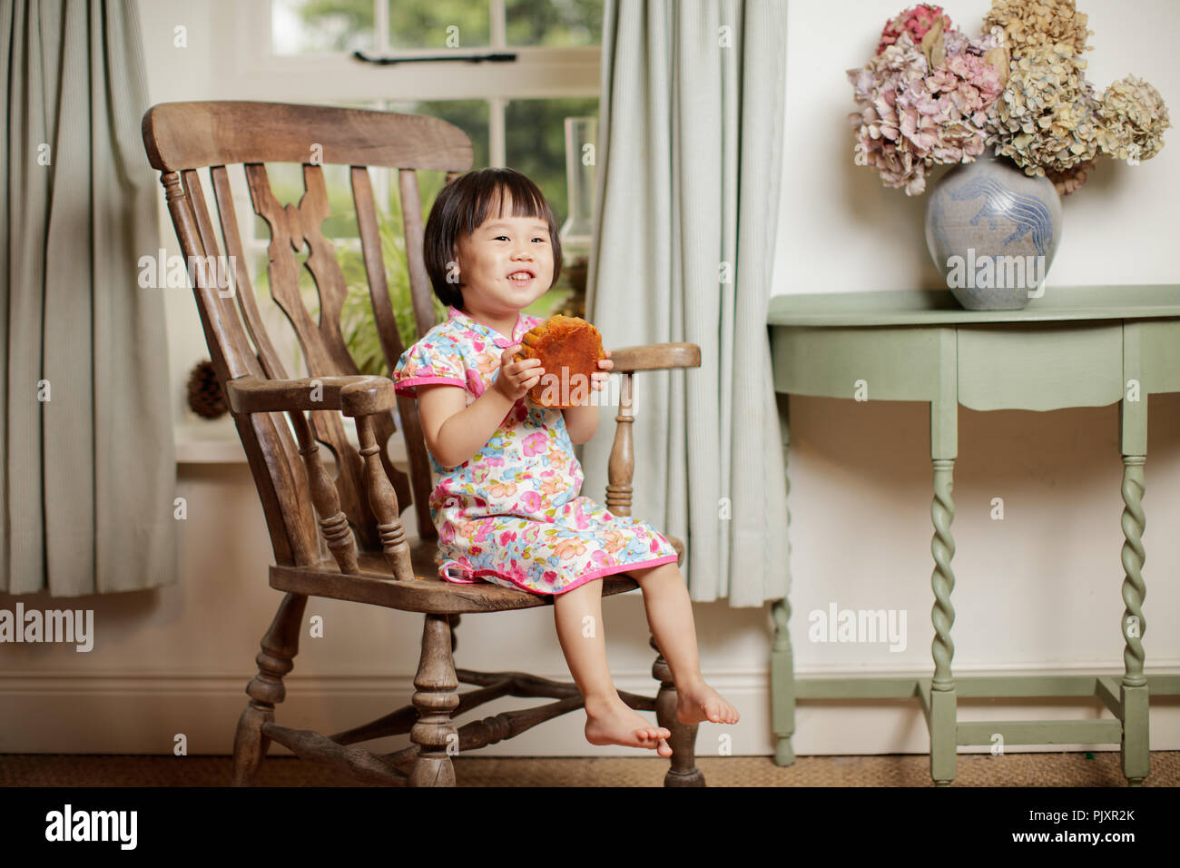baby girl eating mooncake celebrating Chinese middle Autumn day Stock ...