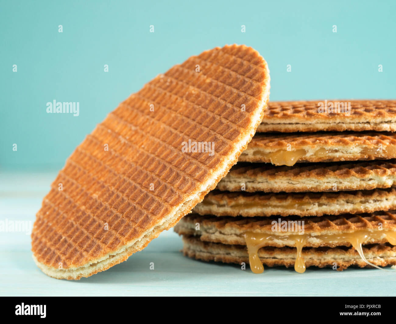 Stroopwafels or caramel Dutch Waffle close up on turquoise wooden ...