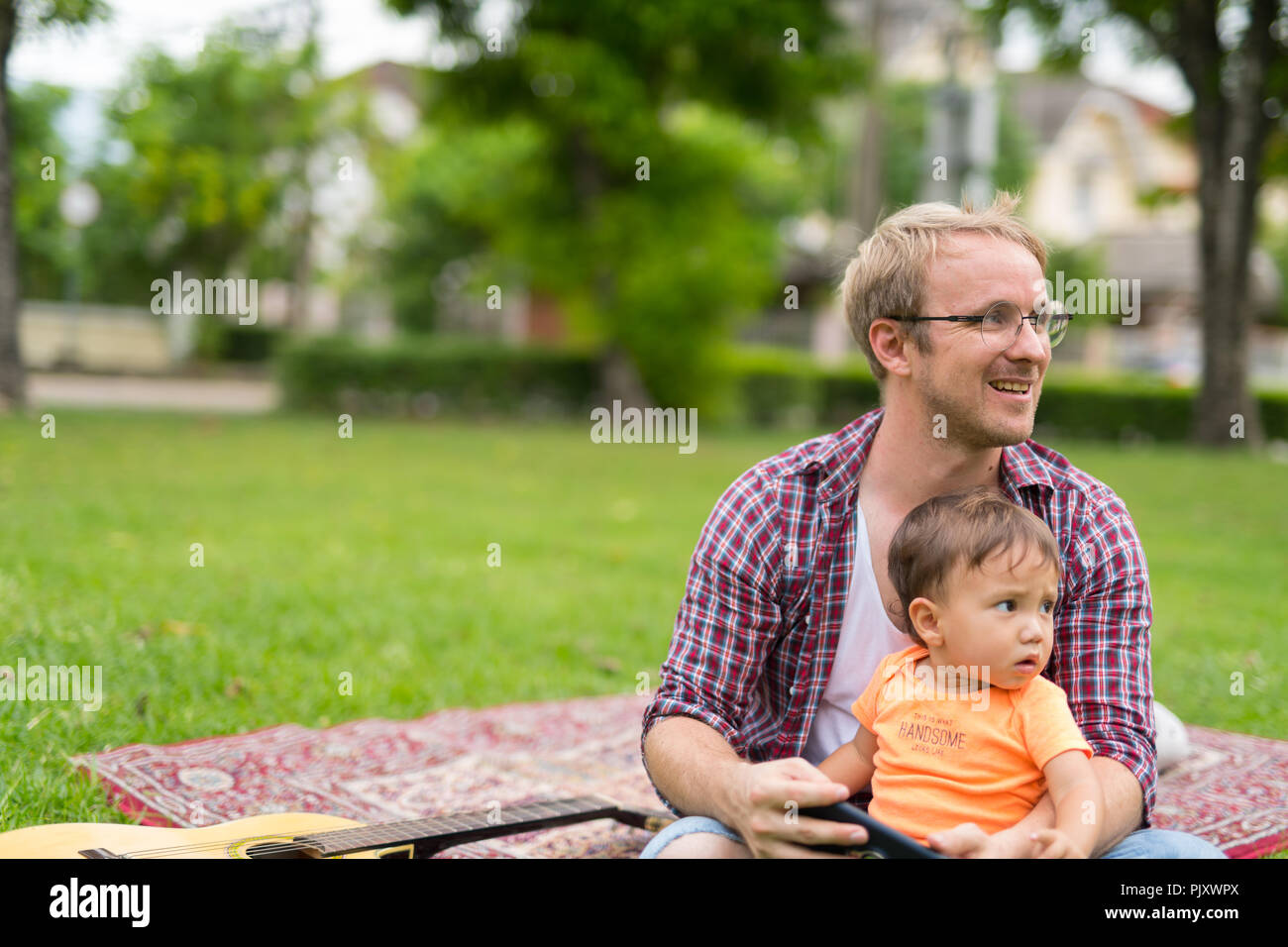 Happy father and baby son bonding together outdoors Stock Photo - Alamy