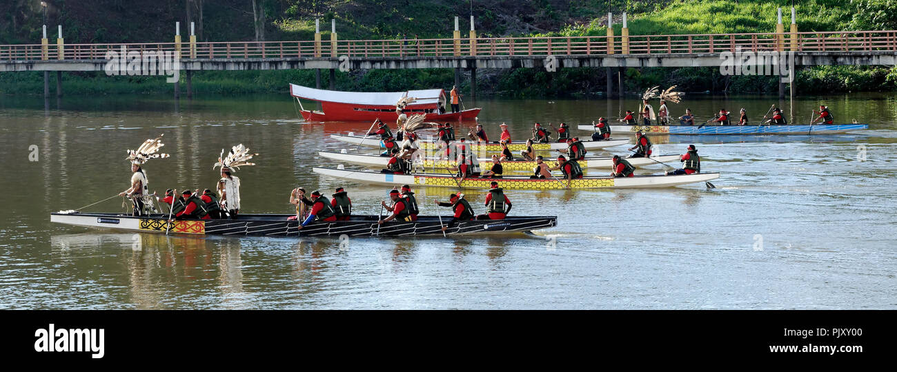Kuching, Sarawak river, boats with natives in traditional dress form ...