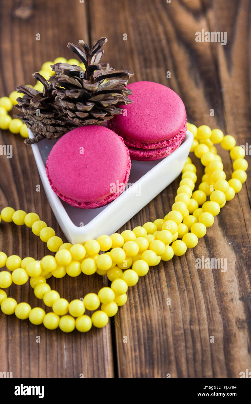 Pink macaroons with christmas decorations on woooden background Stock ...