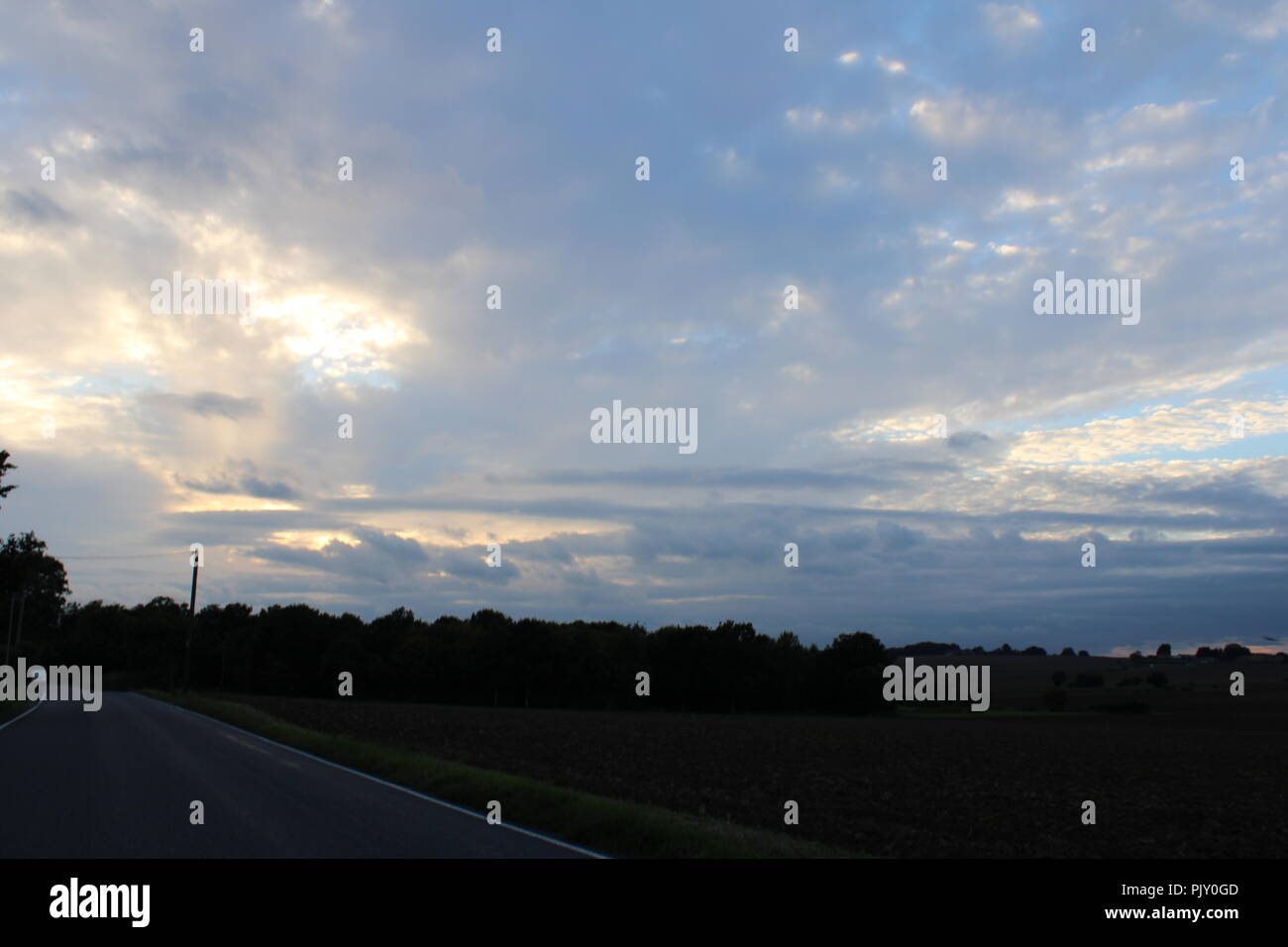 Sun behind light cloud cover hi-res stock photography and images - Alamy