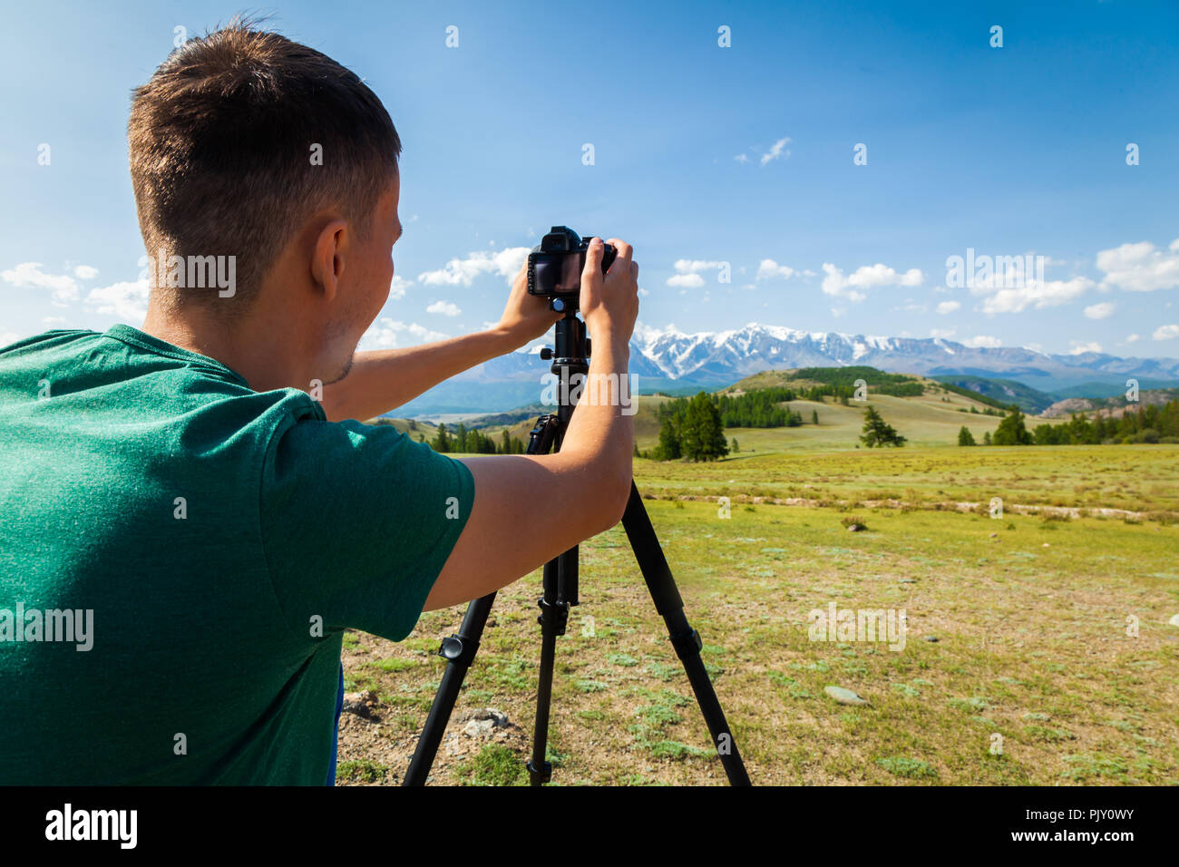 Travel hiking man shoooting mountain landscape. Tourist professional ...