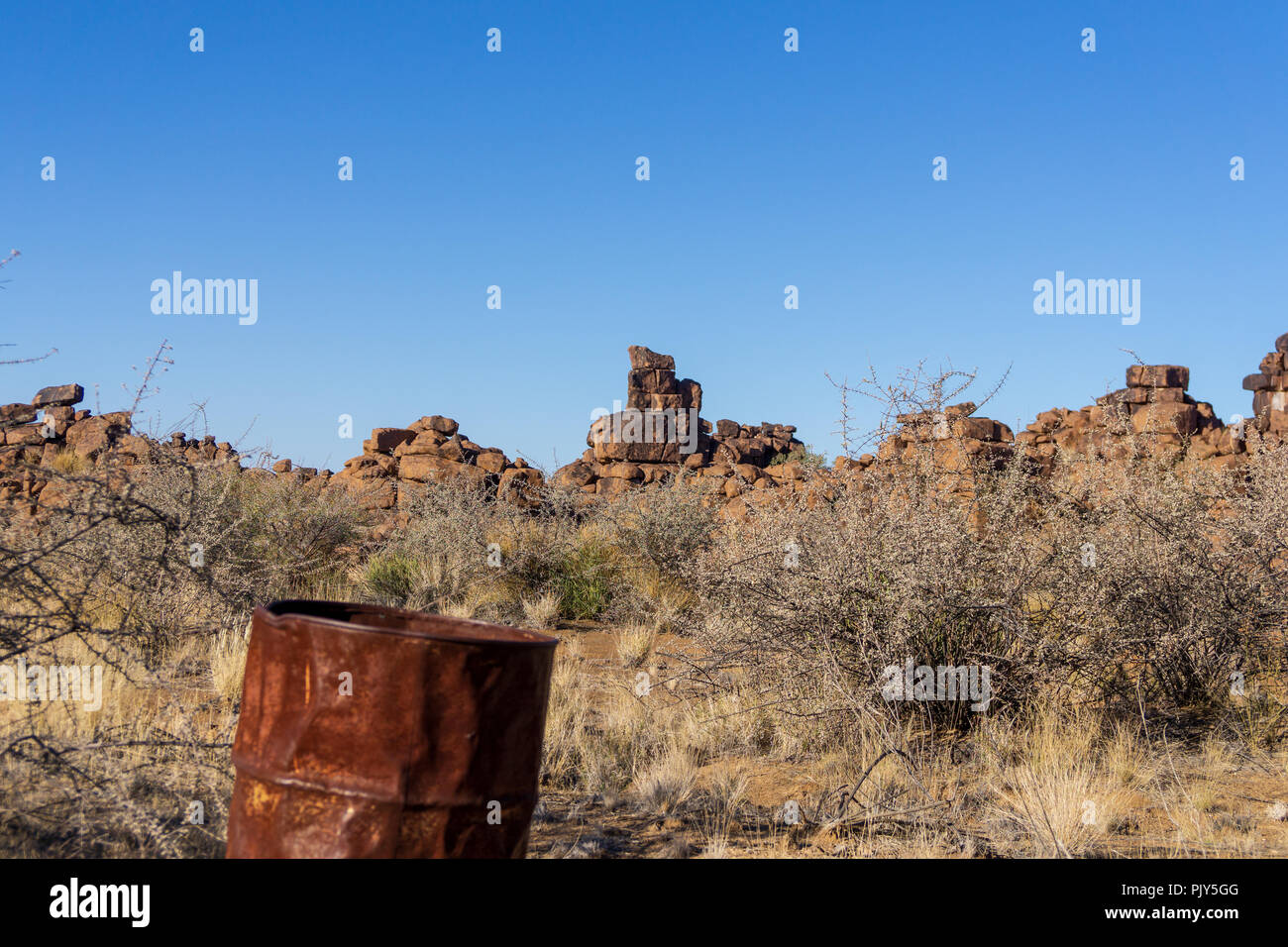 desert rust barrel rocks sky summer Stock Photo - Alamy