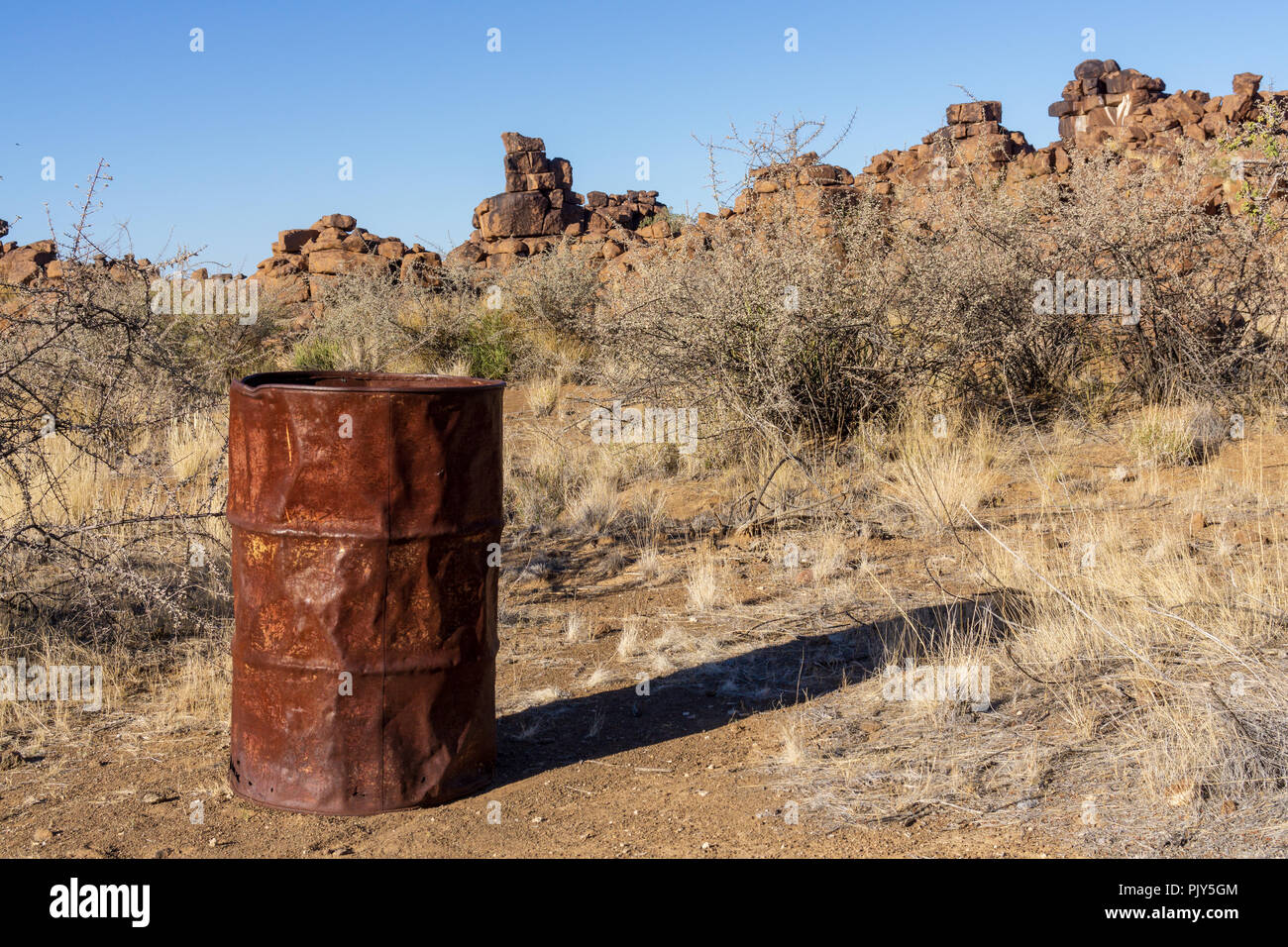 rust barrel desert rock summer Stock Photo - Alamy