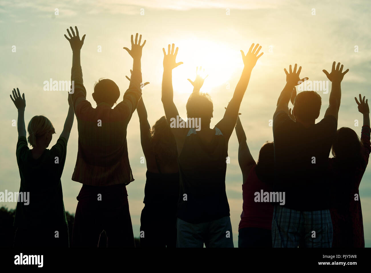 People raising hands up, rear view Stock Photo - Alamy