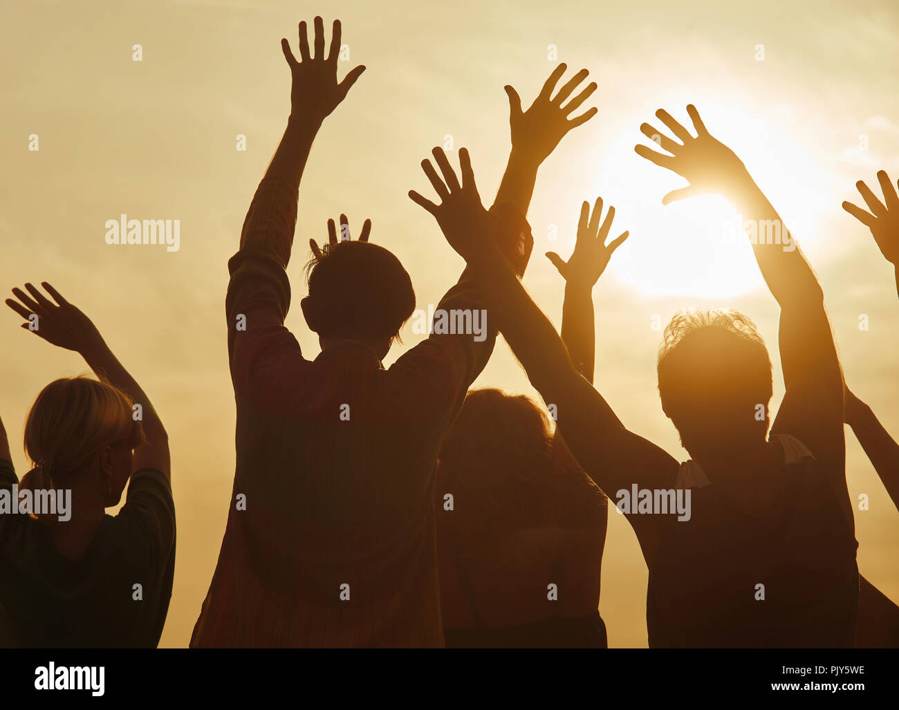 People silhouette with hands up Stock Photo - Alamy