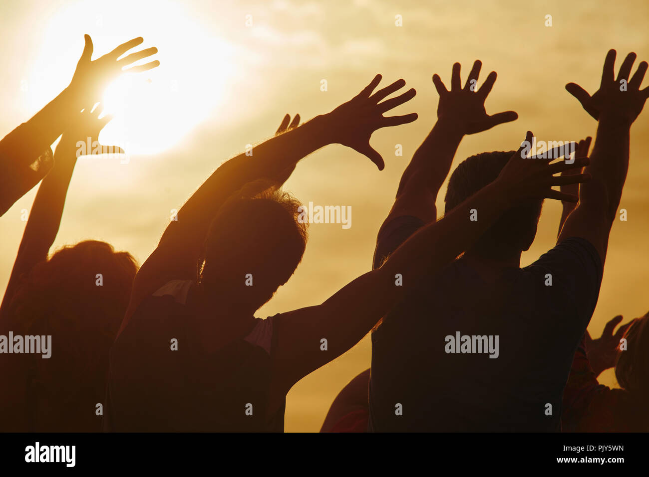 People touching the golden sunshine glow Stock Photo - Alamy