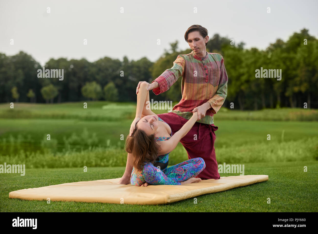 Thai massage stretching exercise Stock Photo - Alamy