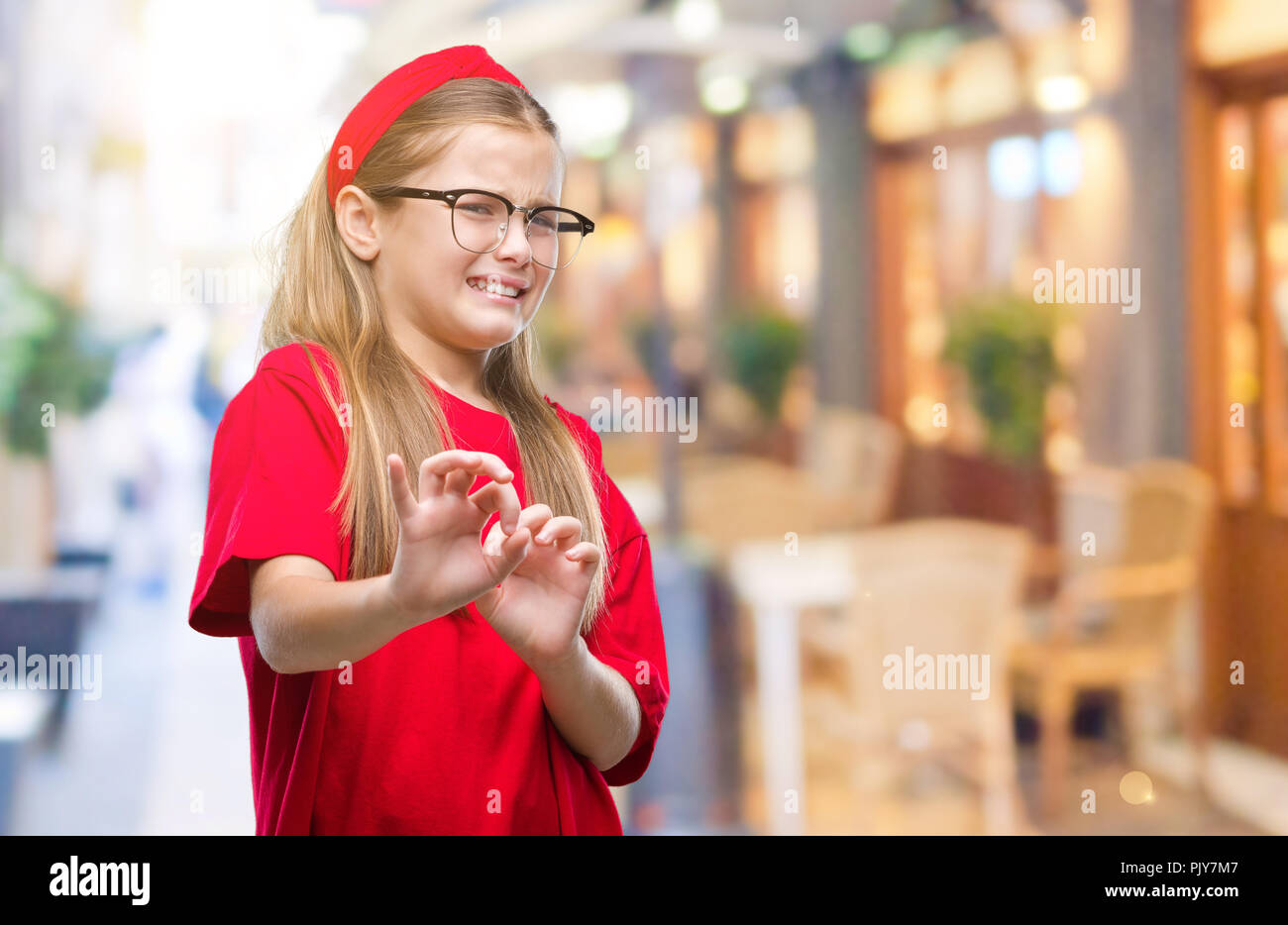 Young beautiful girl wearing glasses over isolated background disgusted ...