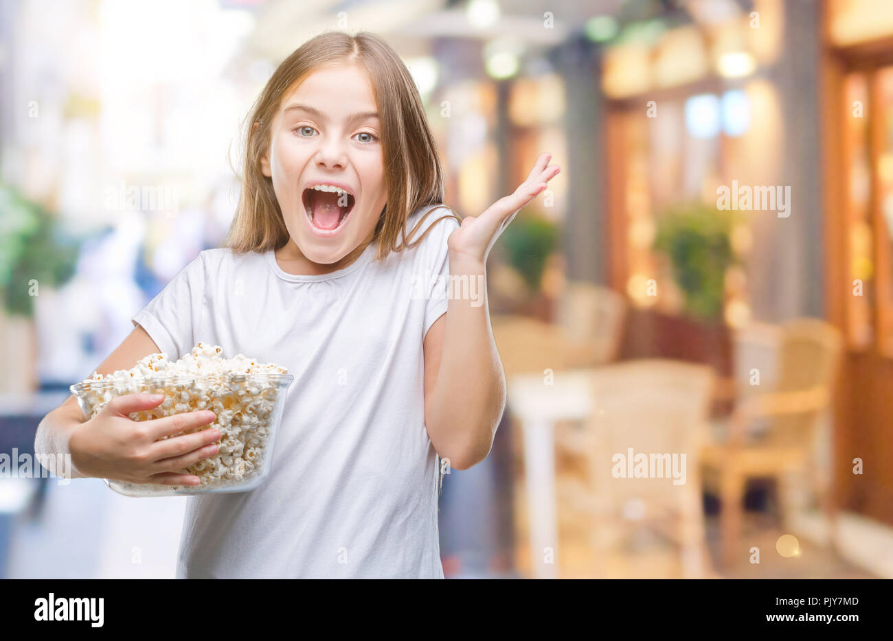 Young beautiful girl eating popcorn snack isolated background very ...